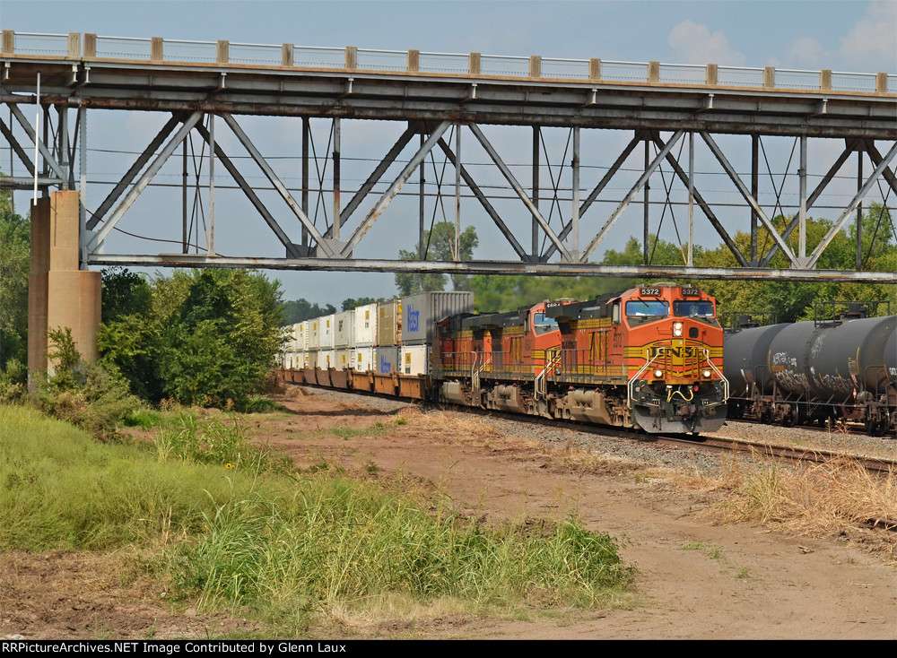 BNSF 5372 leads a southbound stack train under the US-77 bridge